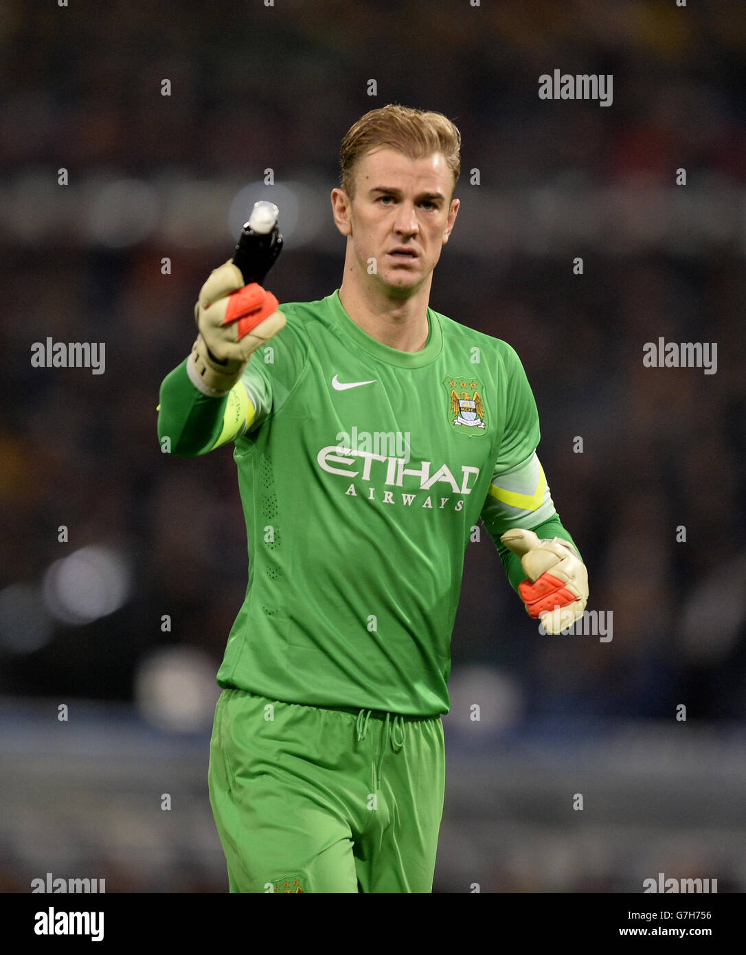 Manchester City goalkeeper Joe Hart picks up a object from the floor ...