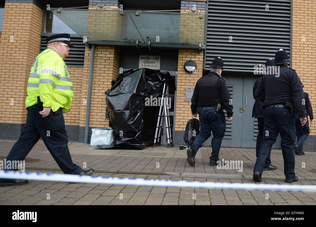 General view of police officers at the murder scene at a block of flats ...