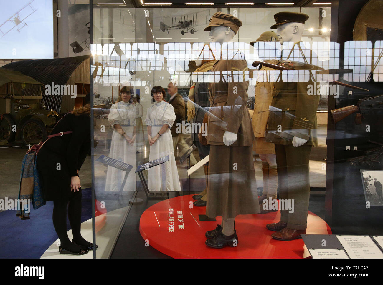 Visitors looking a display of vintage uniforms on show, during a ...