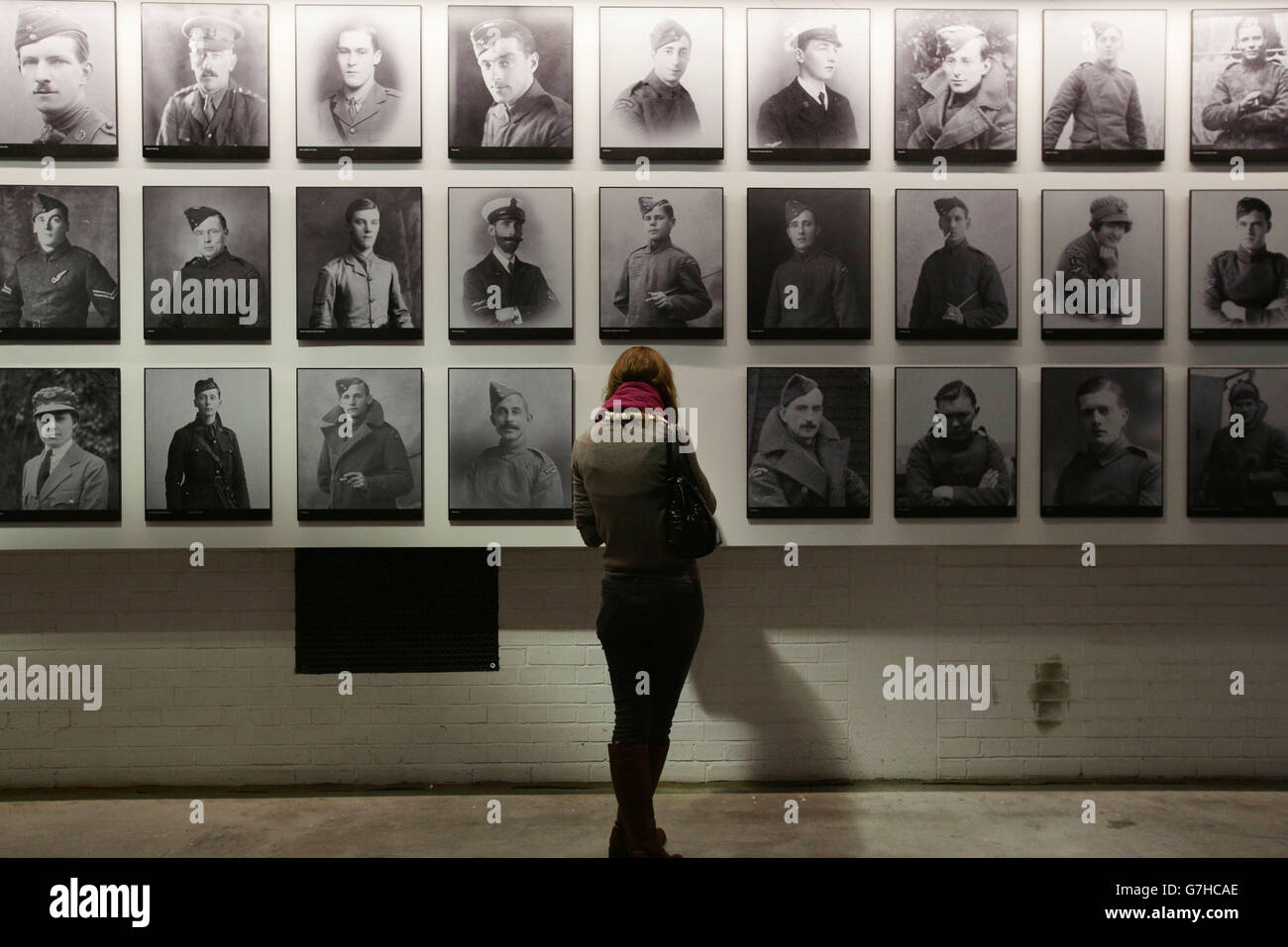 A visitor in front of a wall of portraits of RAF personnel, during a ...