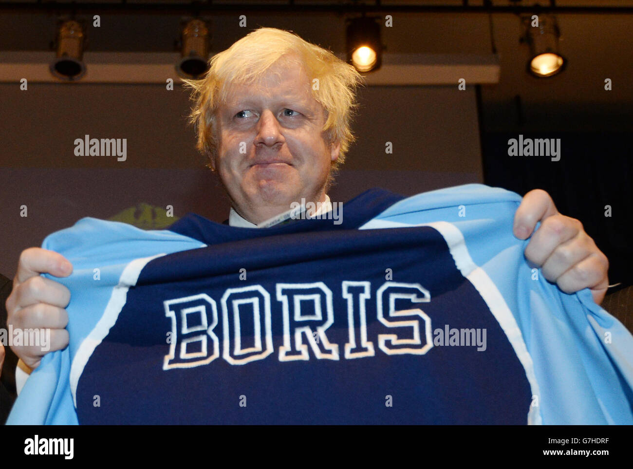 Mayor of London Boris Johnson is presented with a sports top bearing ...