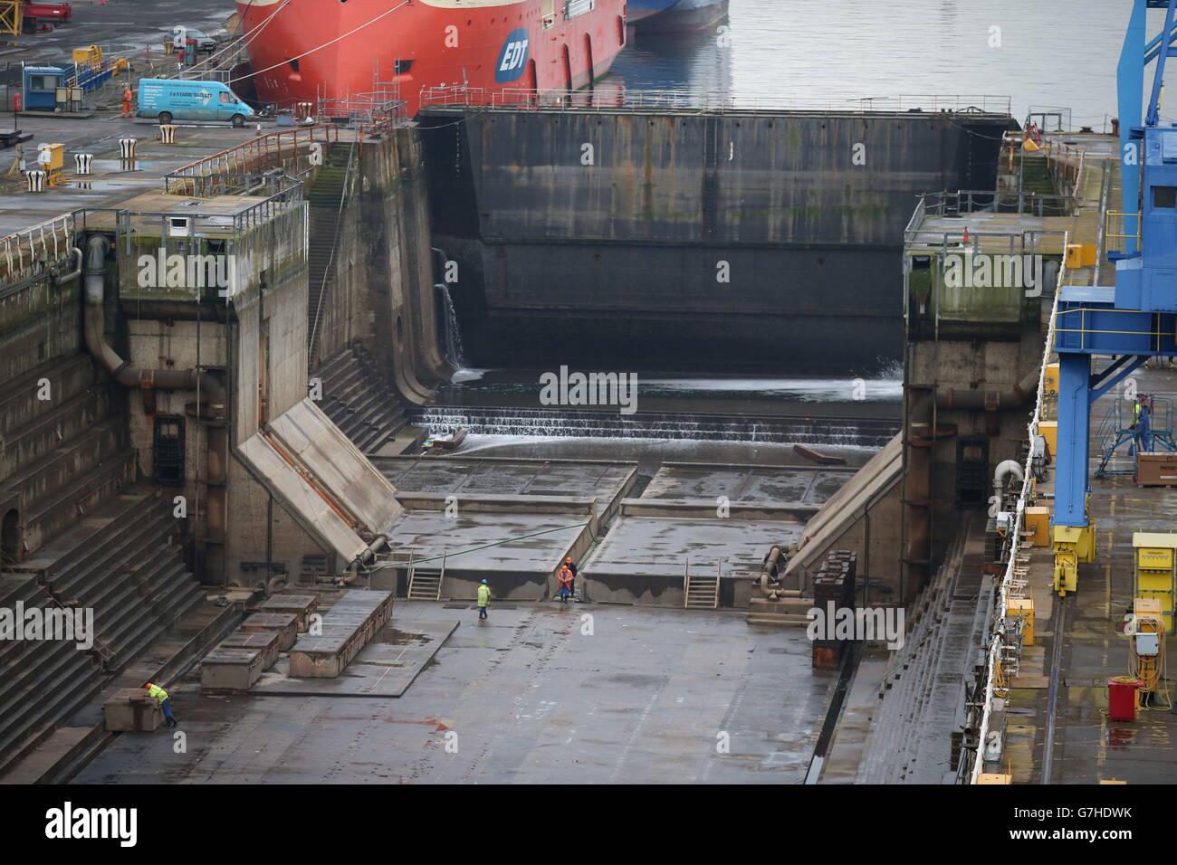 Workmen walk across the dry dock, as Defence Secretary Michael Fallon ...