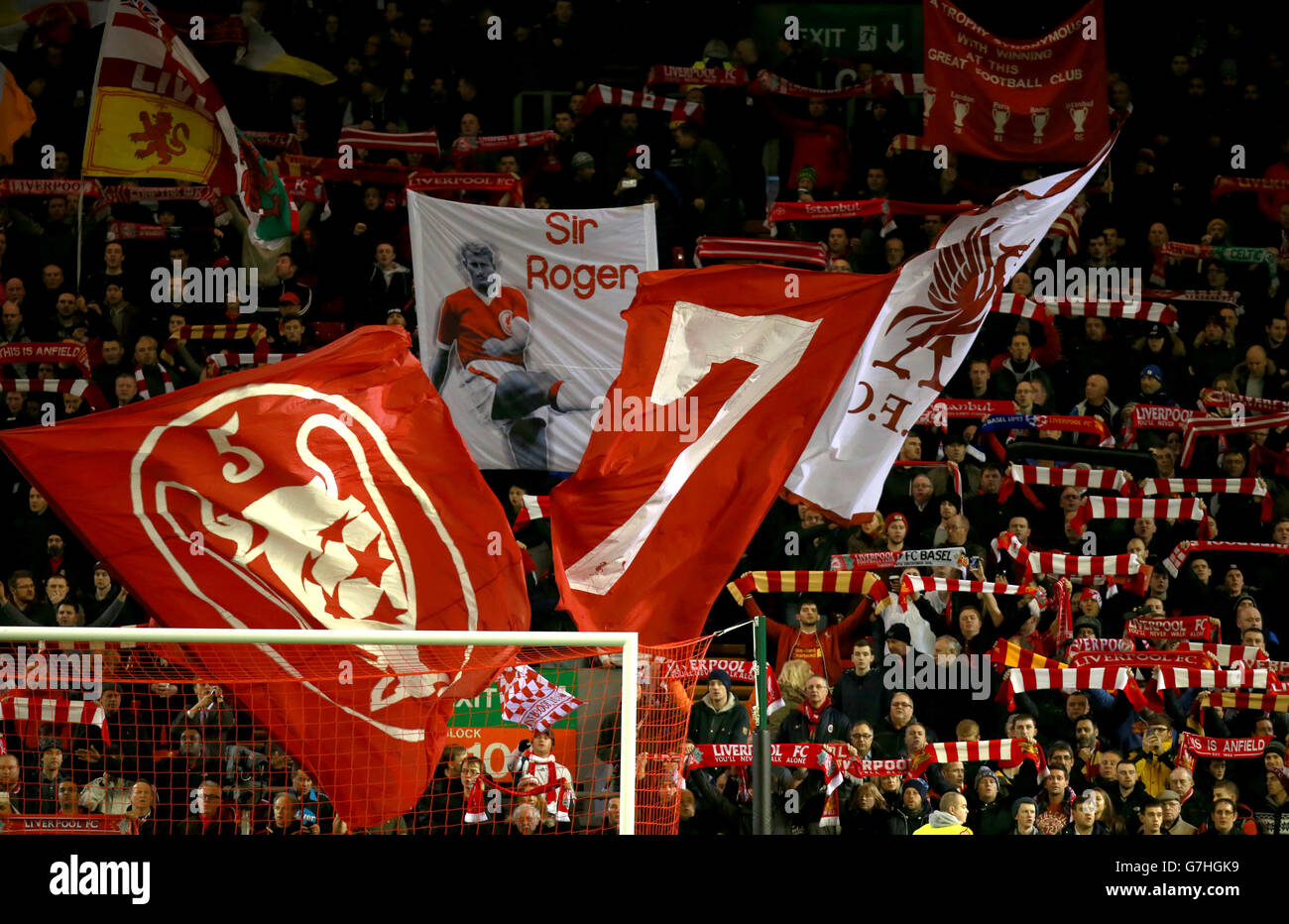Liverpool fans cheer on their side in the stands by waving scarfs and ...
