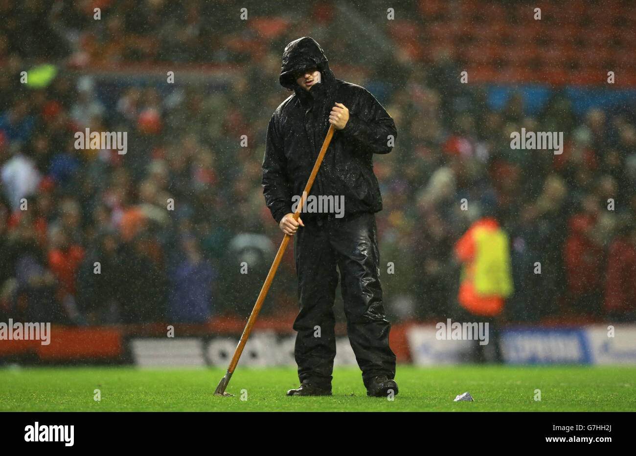 A member of the grounds staff tends to the pitch at half time during ...