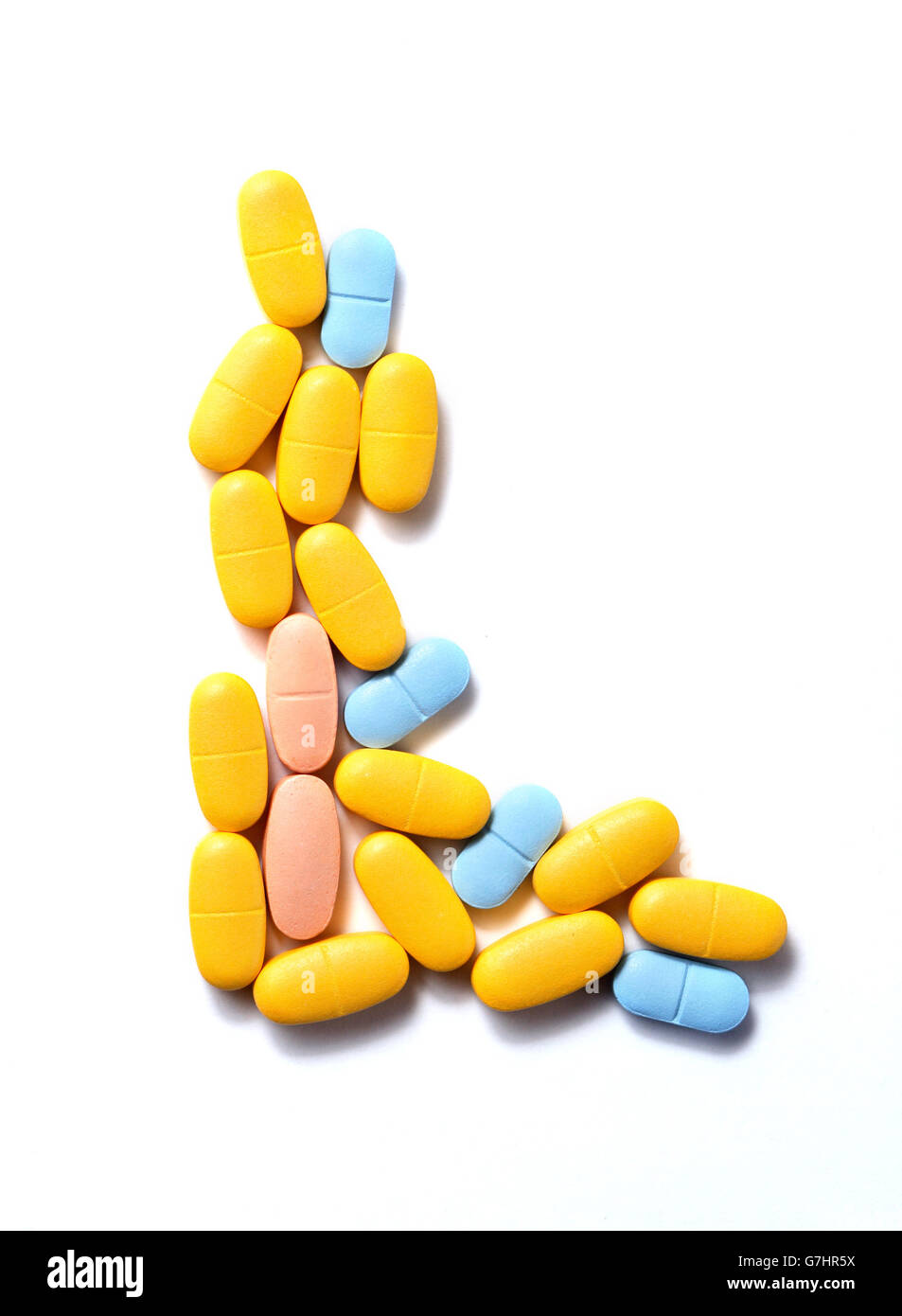 Colored pills set as border on white background Stock Photo - Alamy