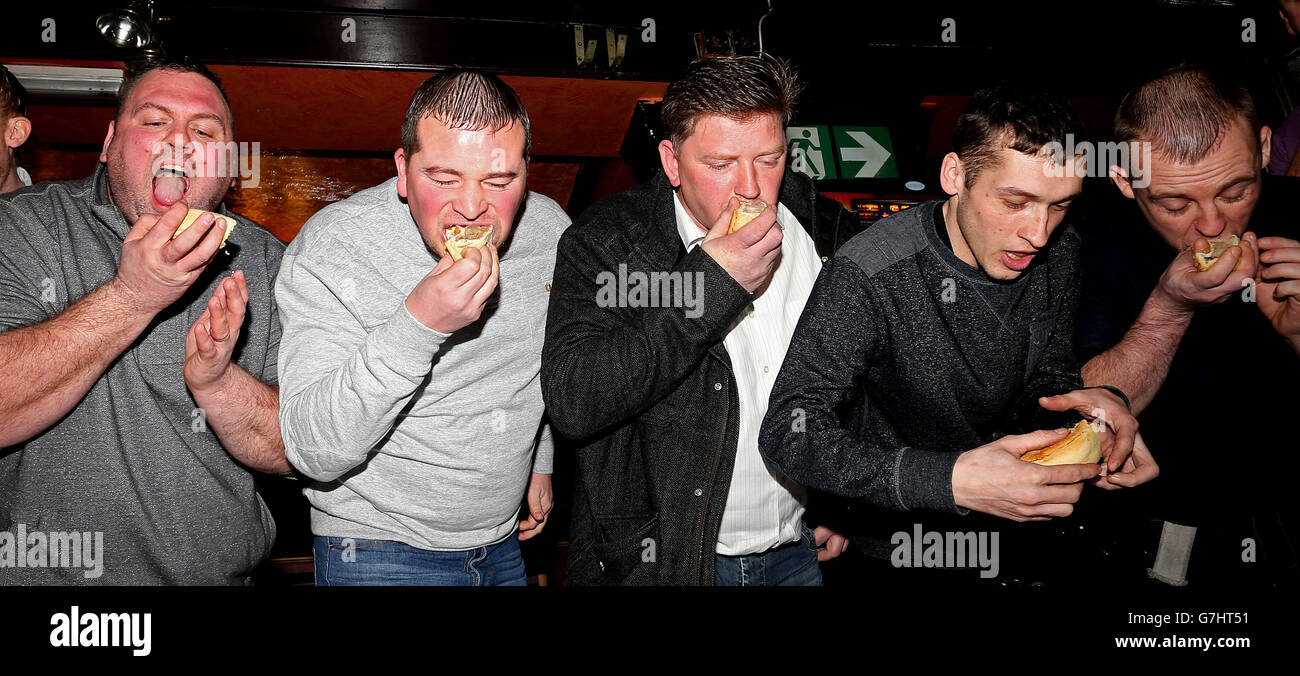 Contestants take part in the World Pie Eating Championships at Harry's ...