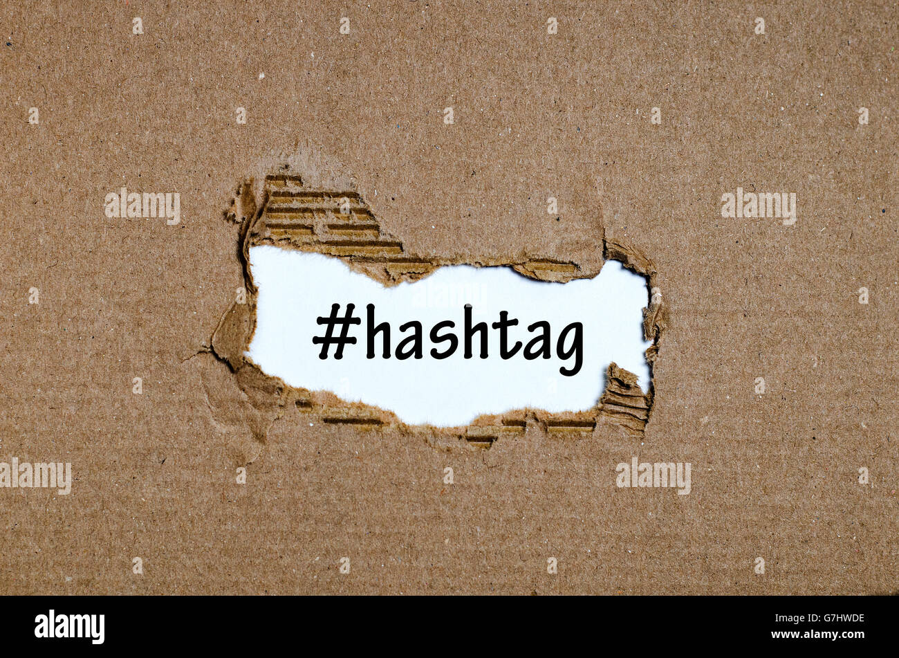 The word hashtag appearing behind torn paper Stock Photo - Alamy