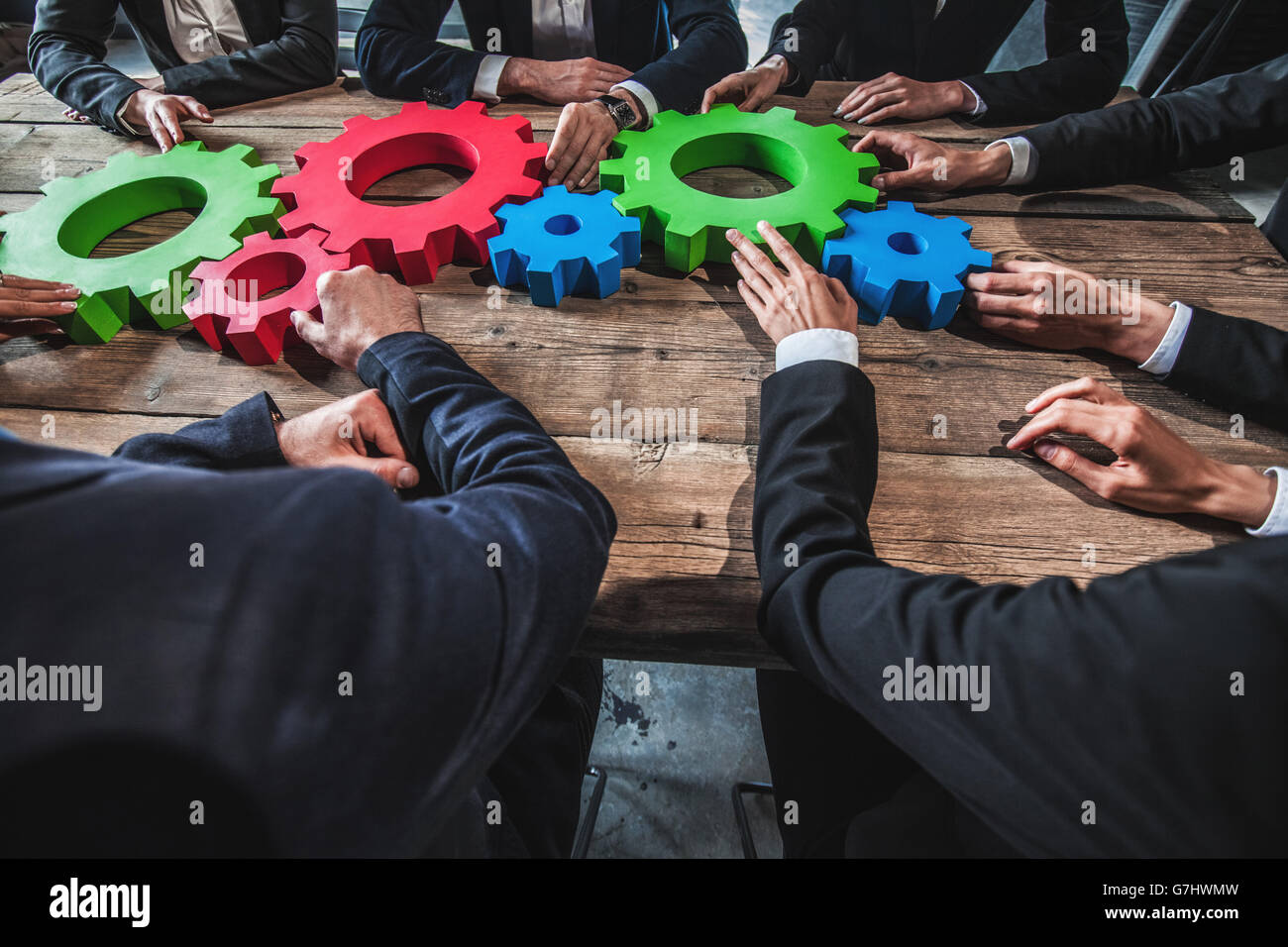 Business people with cogs of business, modern business meeting concept ...