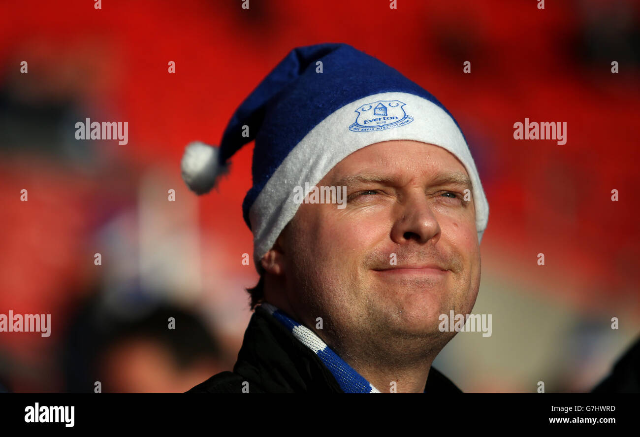 A Everton fan wears a blue santa hat in the stands before the start of ...