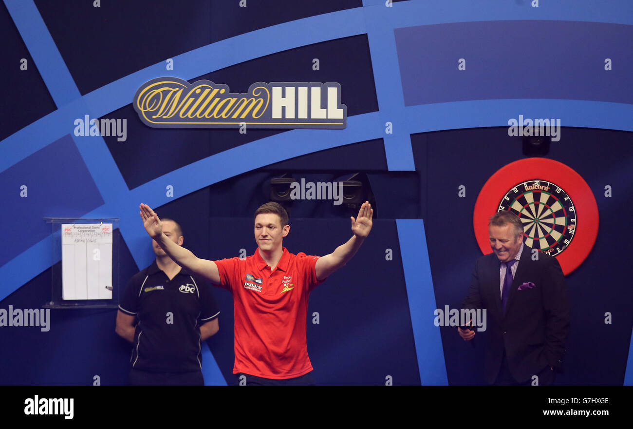 David Pallett waves to the crowd as he walks on for his match against ...