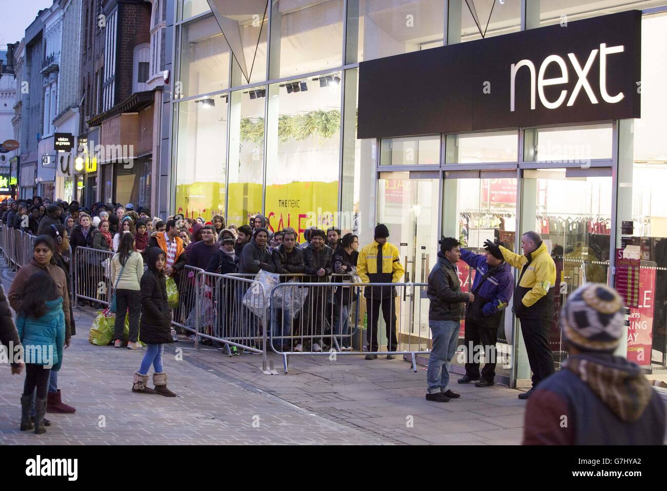 Shoppers queue outside Next at the Centrale shopping centre in Croydon ...