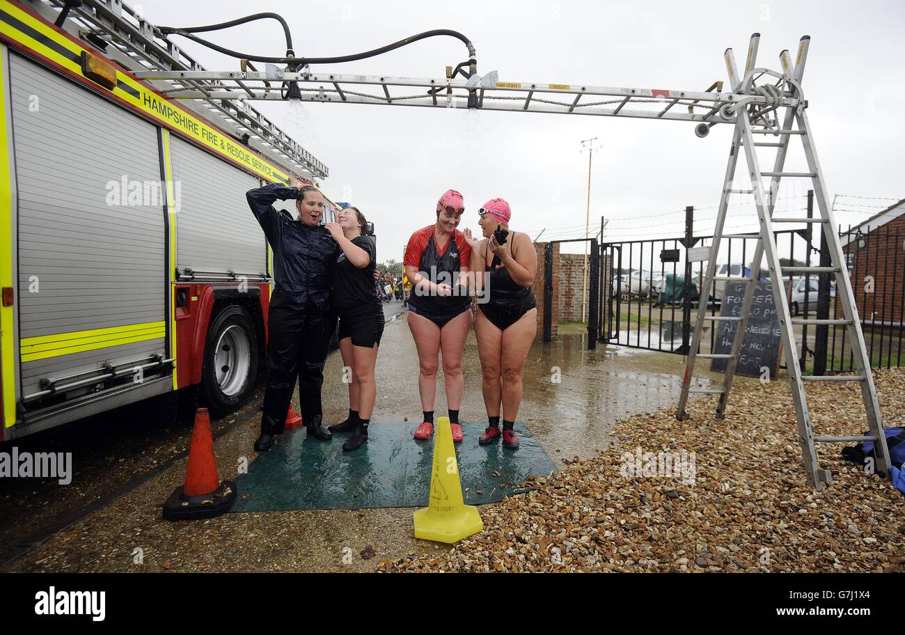Swimmers make use of a hot shower provided by the Hampshire Fire and ...