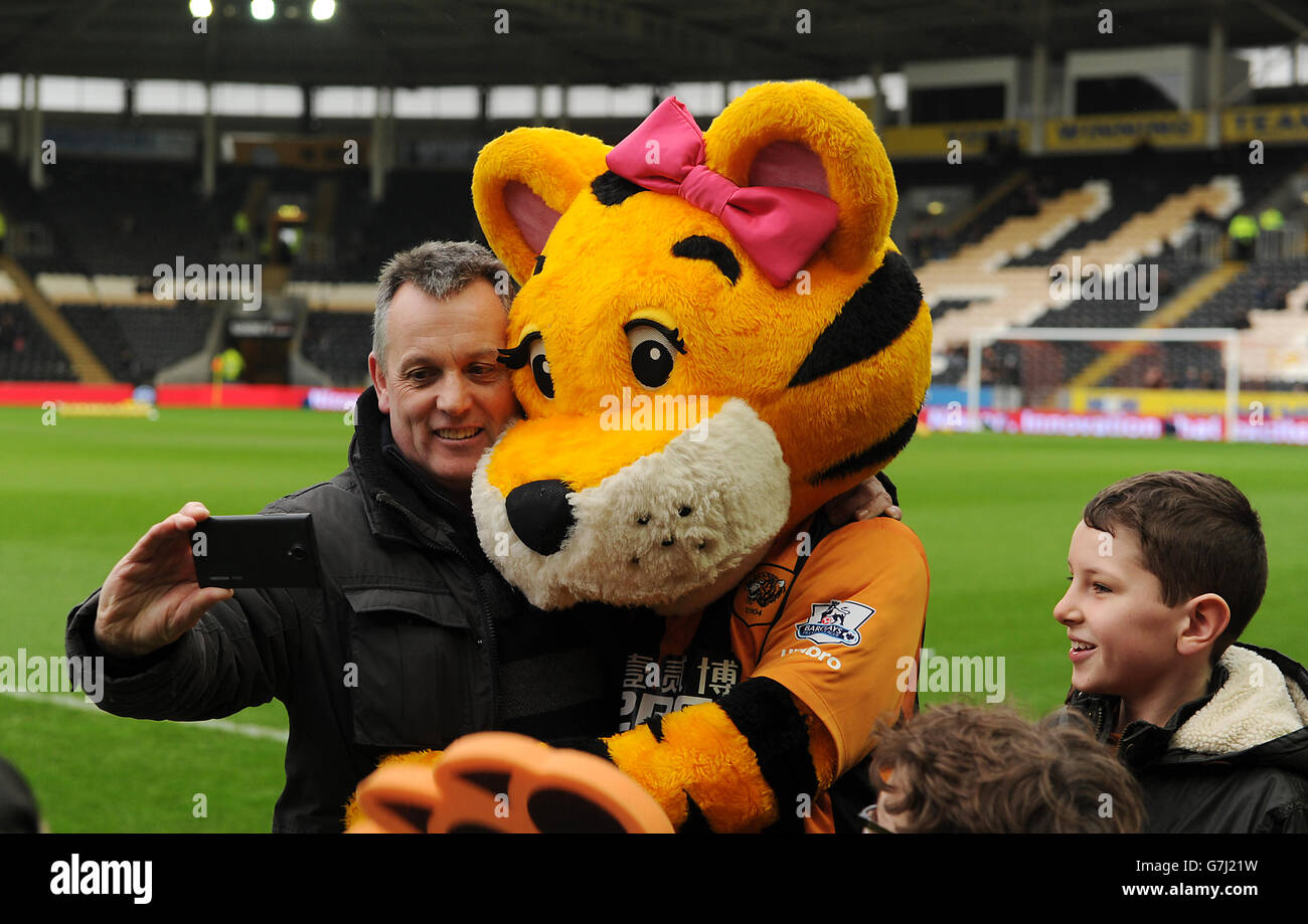 A Hull City fan has a selfie with the club mascot Amber Stock Photo - Alamy