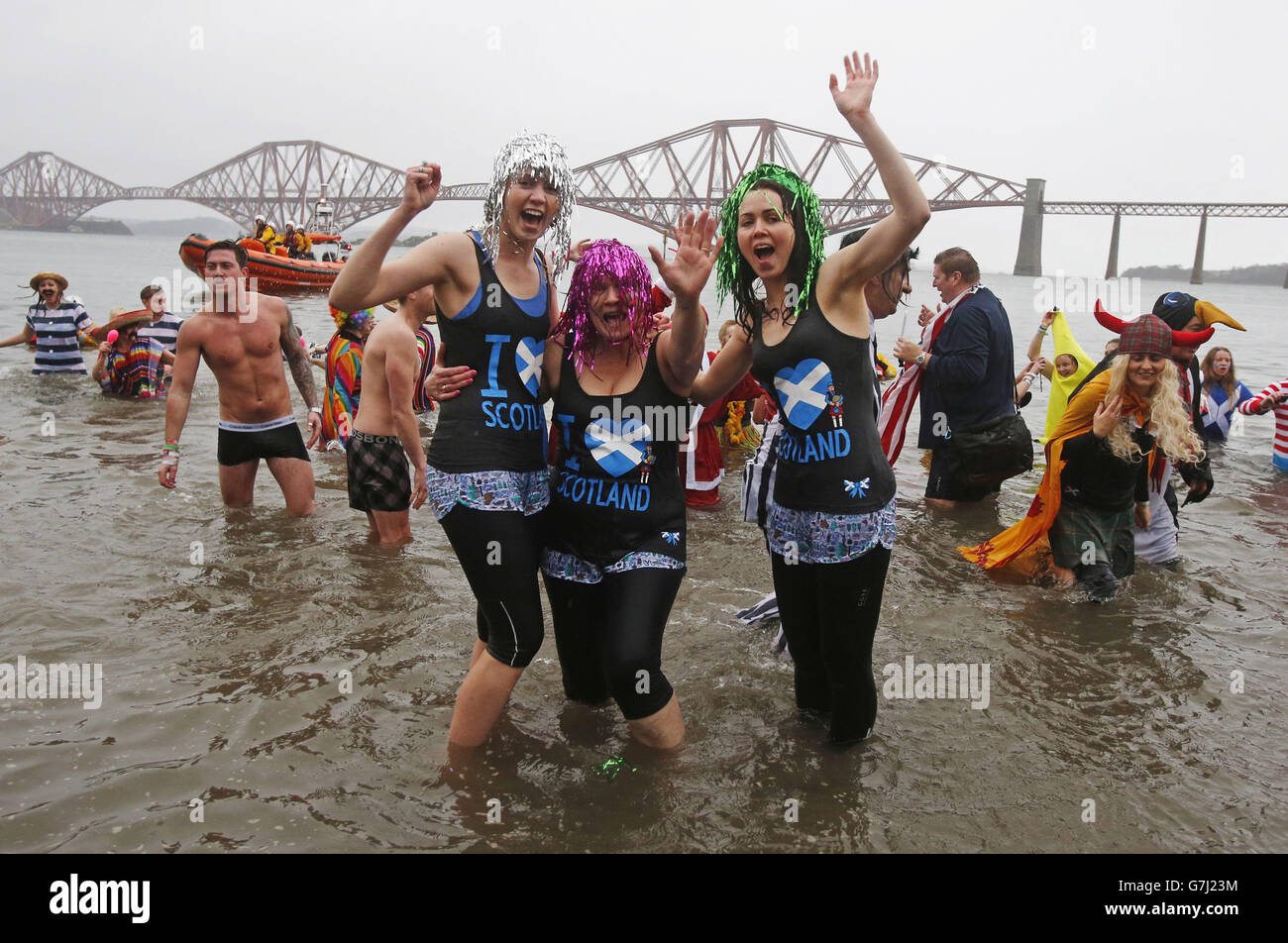 Swimmers take part in the Loony Dook New Year's Day dip in the Firth of ...