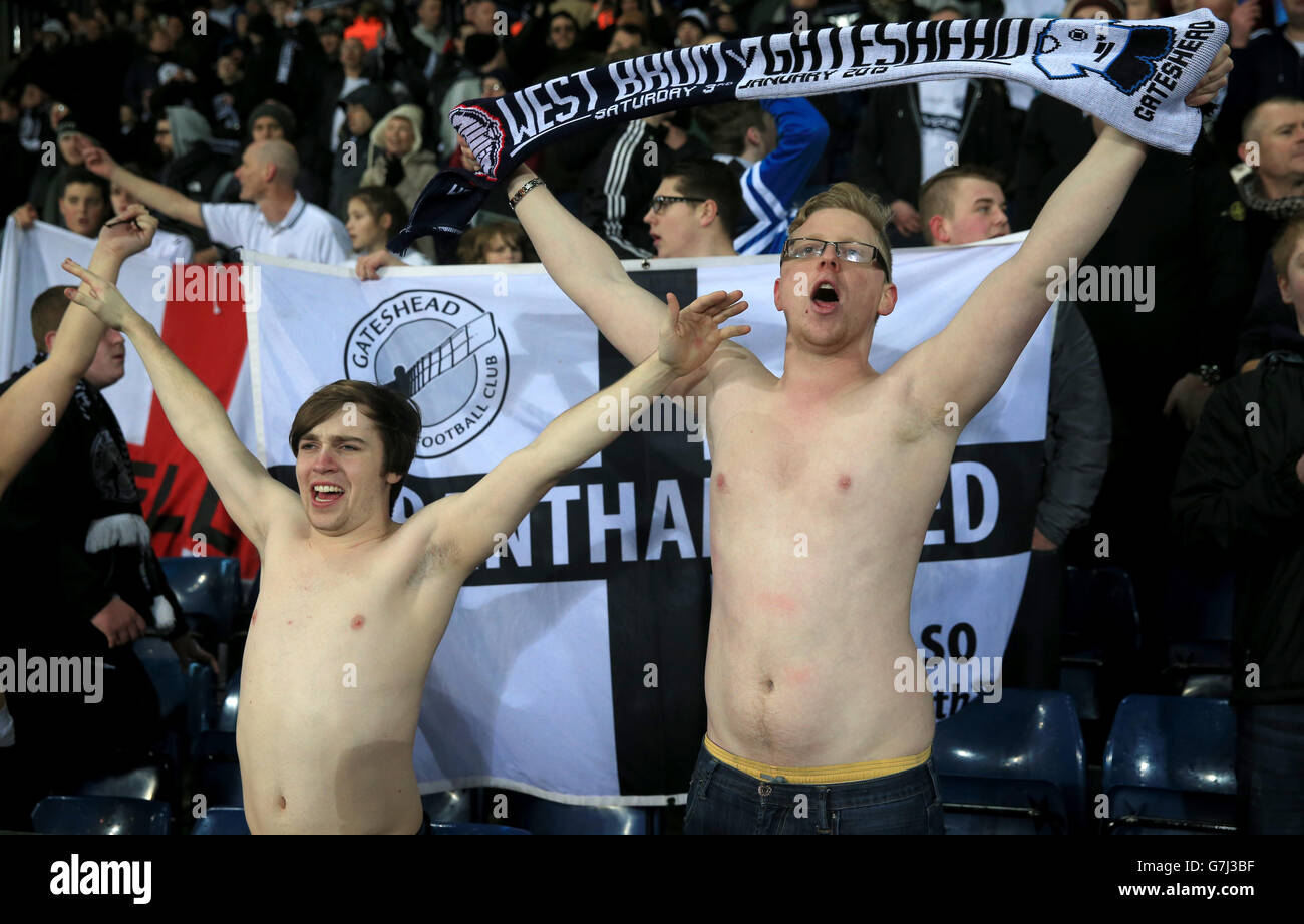 Shirtless Gateshead fans cheer on their side in the stands during the ...