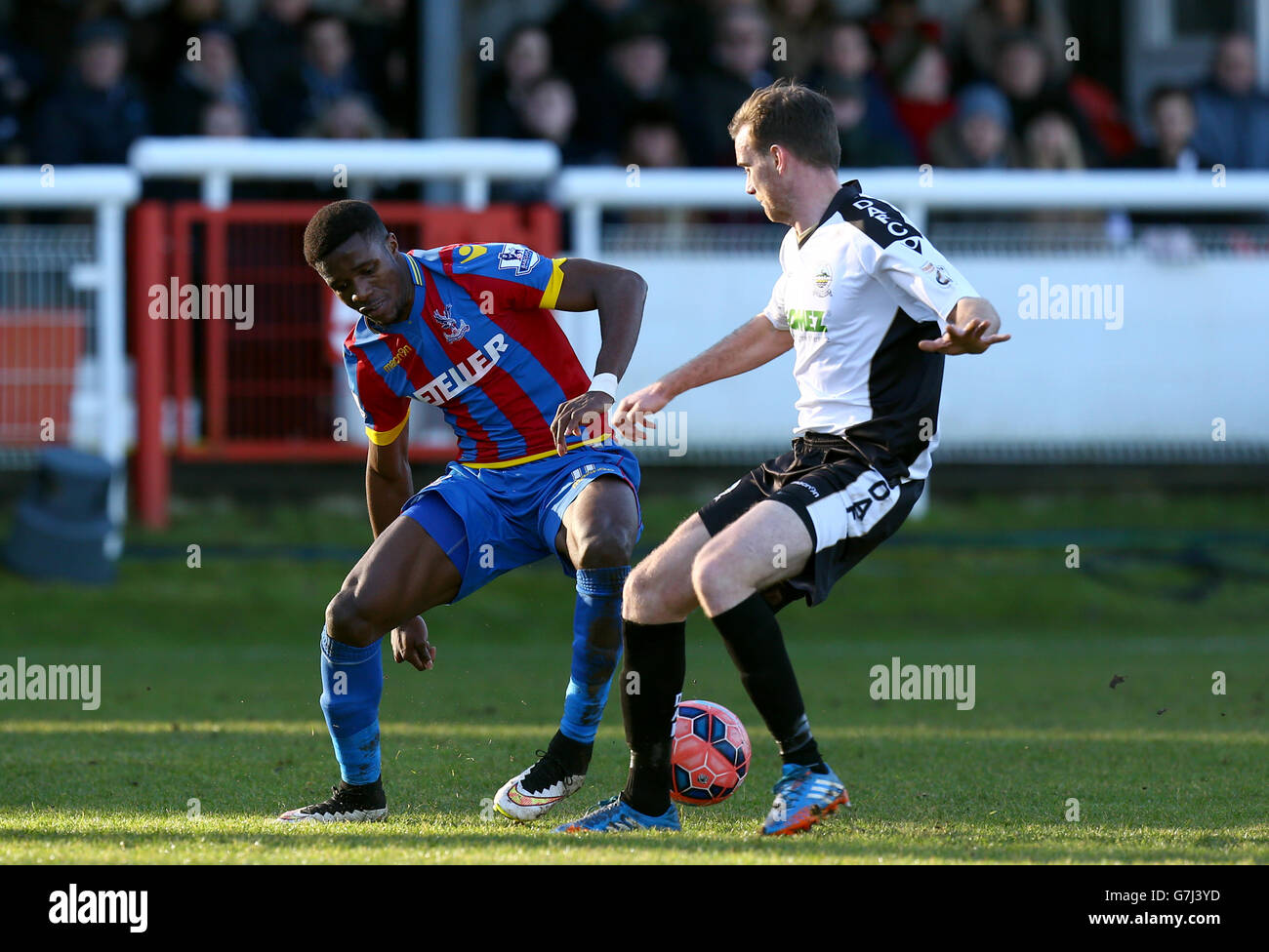 Crystal Palace's Wilfried Zaha (left) and Dover Athletic's Barry Cogan ...