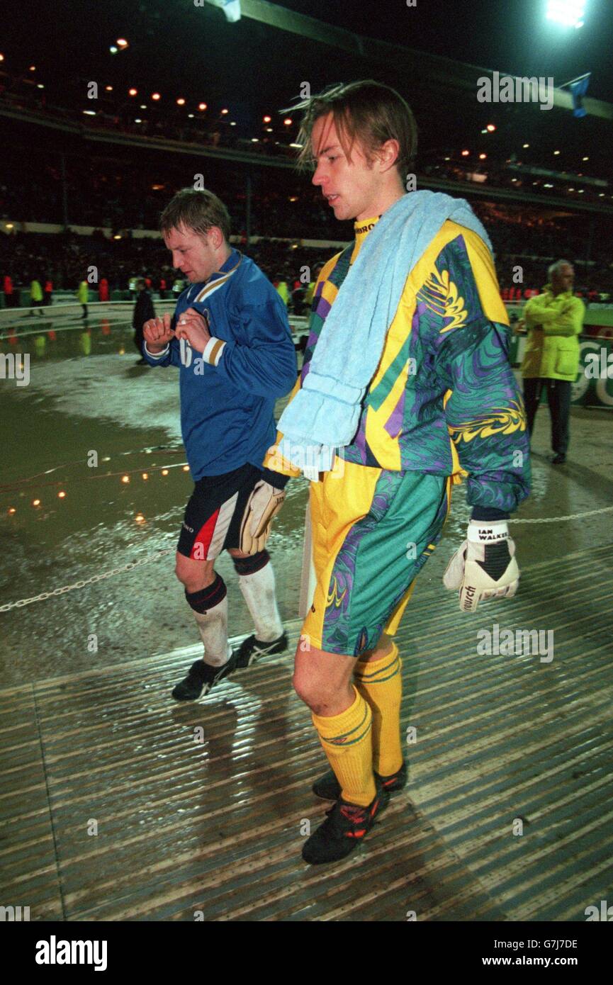 A dejected Ian Walker and David Batty leave the pitch after Englands 1 ...