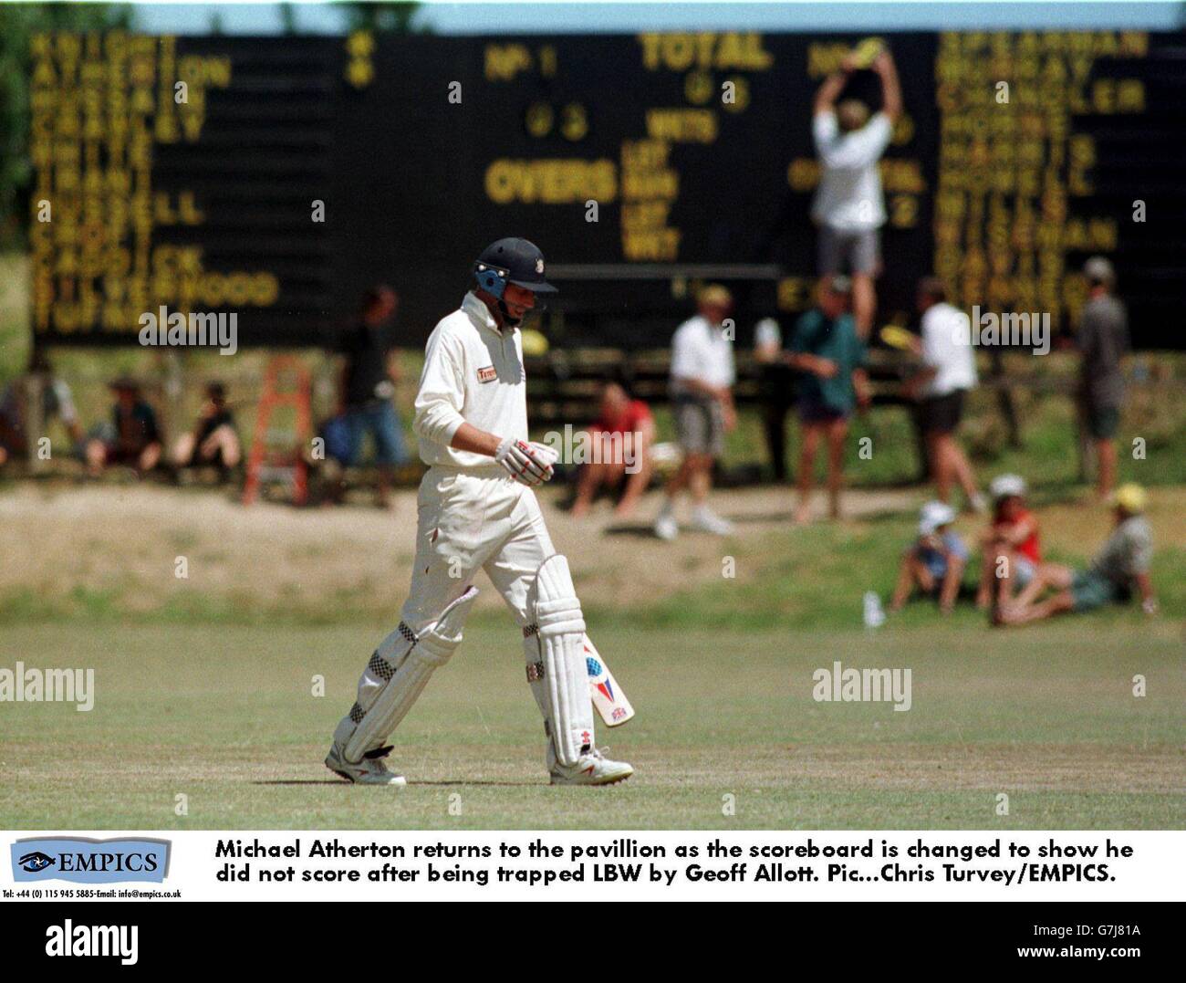 Michael Atherton returns to the pavillion as the scoreboard is changed ...