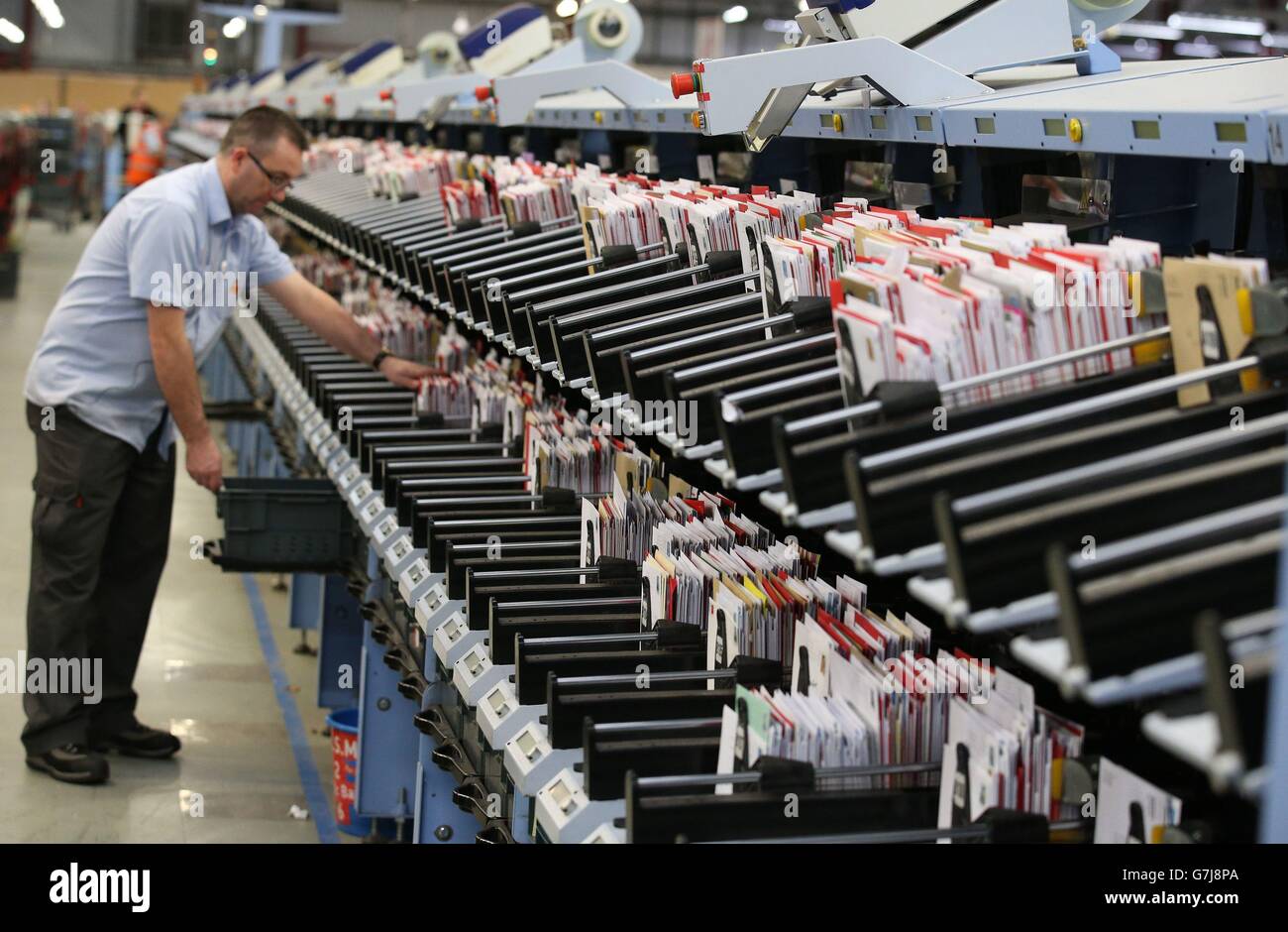 Royal Mail employee sorts mail at Royal Mail's Glasgow mail centre at ...