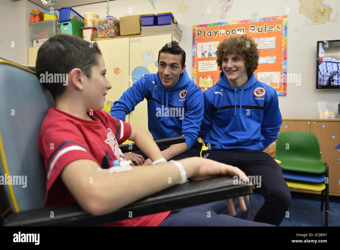 Reading's Stephen Kelly (centre) and Aaron Kuhl chat with a patient ...
