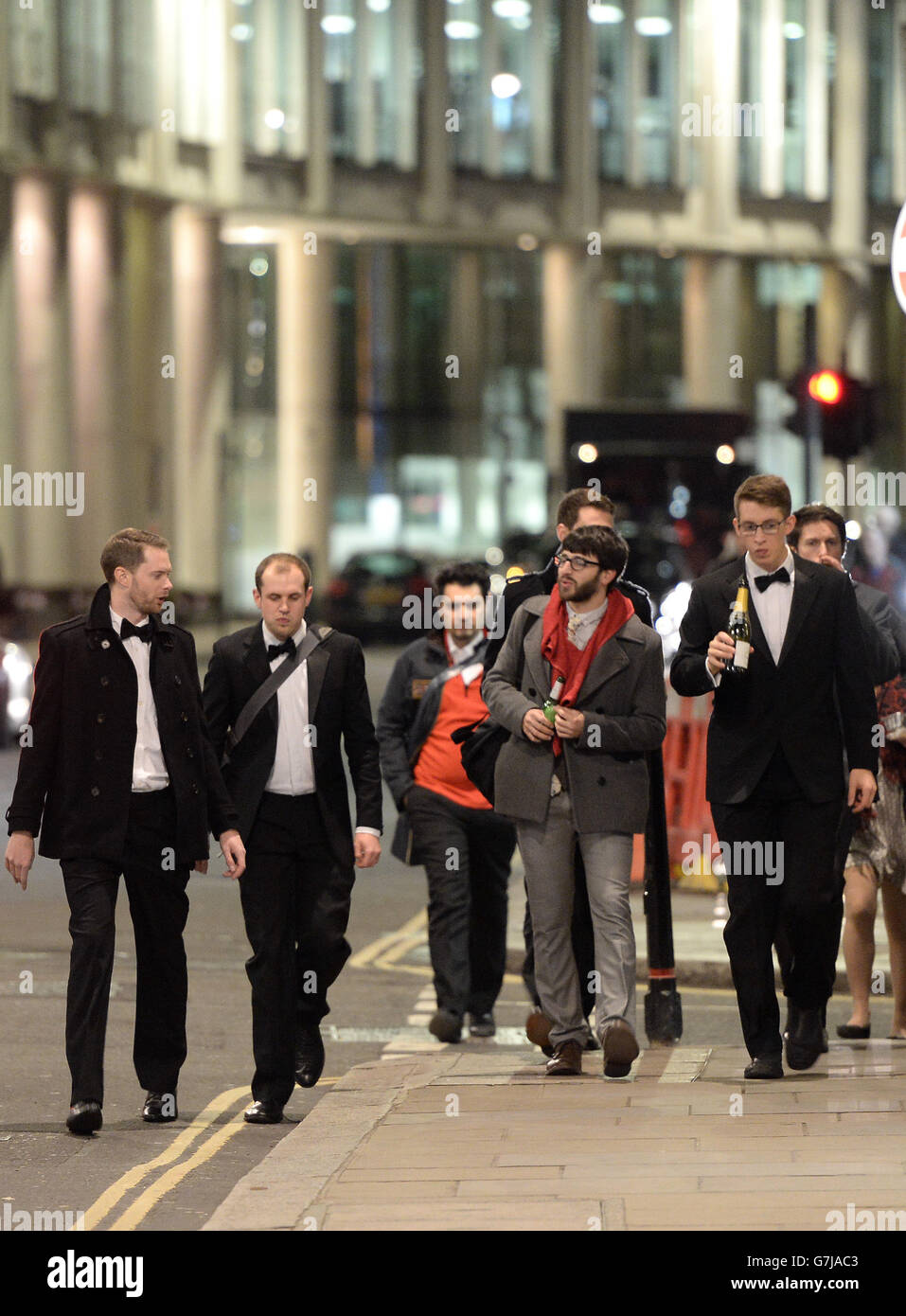 Party goers walk through central London on the last Friday before ...