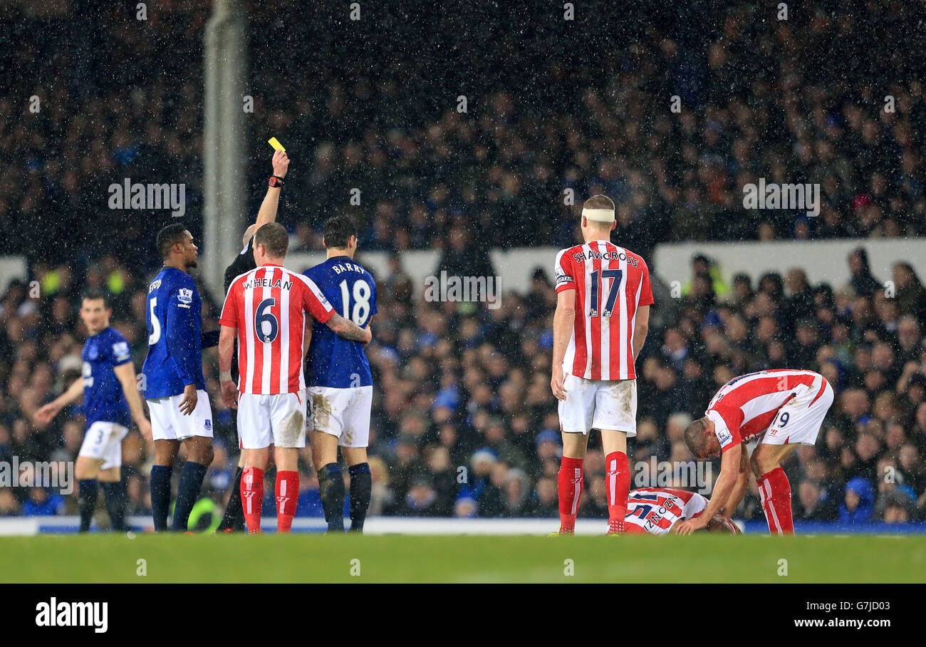 Everton's Gareth Barry is shown a yellow card by Referee Lee Mason ...