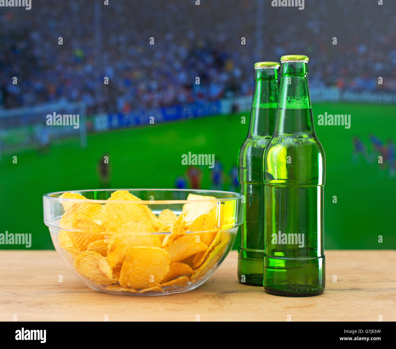 Beer and chips in front of TV with football match Stock Photo - Alamy