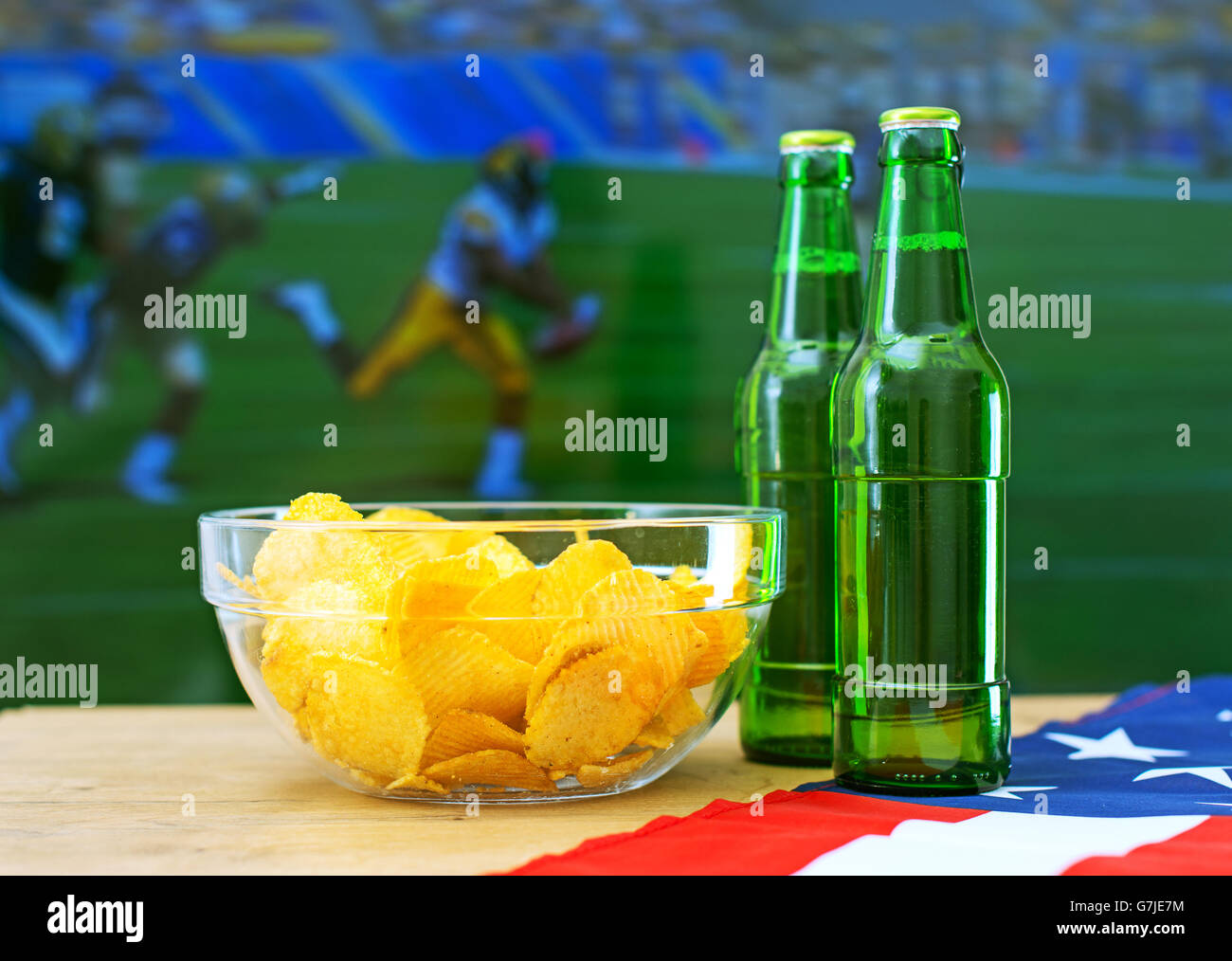 Beer and chips in front of TV with American football match Stock Photo ...