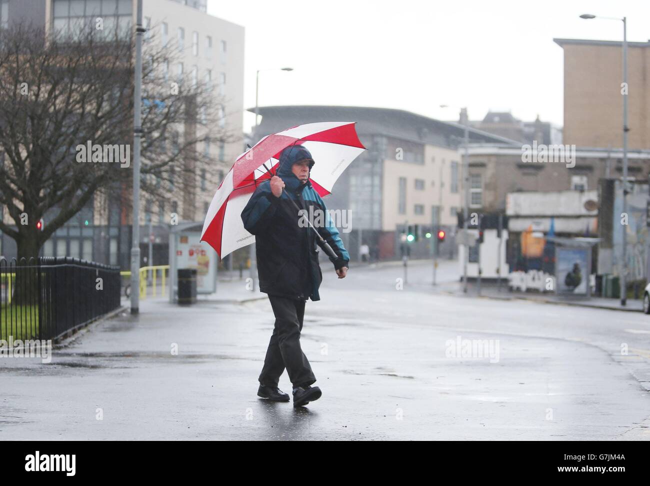 A man with an umbrella in Glasgow, Scotland, as bad weather continues ...