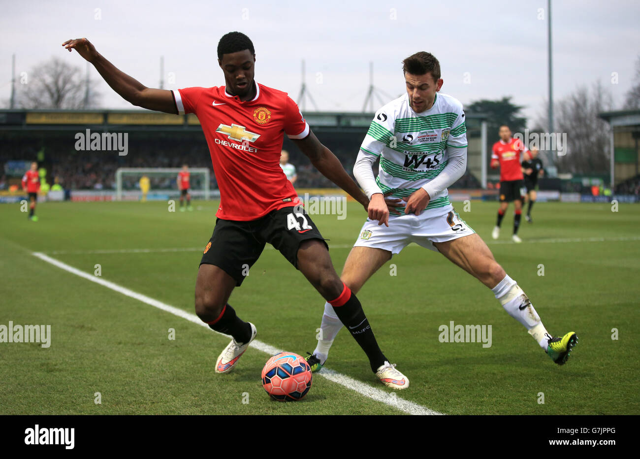 Yeovil Town's Kevin Dawson (right) and Manchester United's Tyler ...