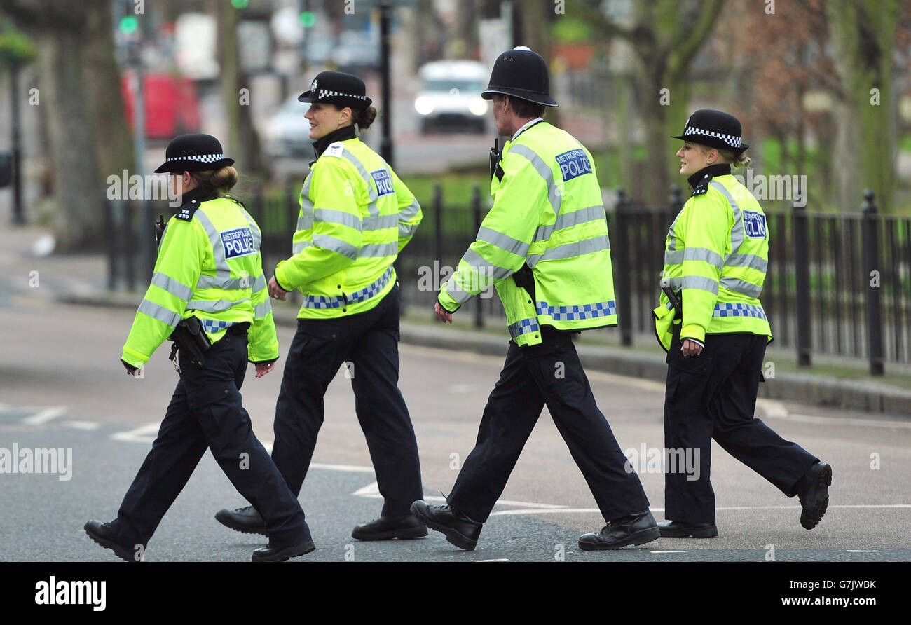 Four Police Officers cross a road in Hornsey, London. PRESS ASSOCIATION ...