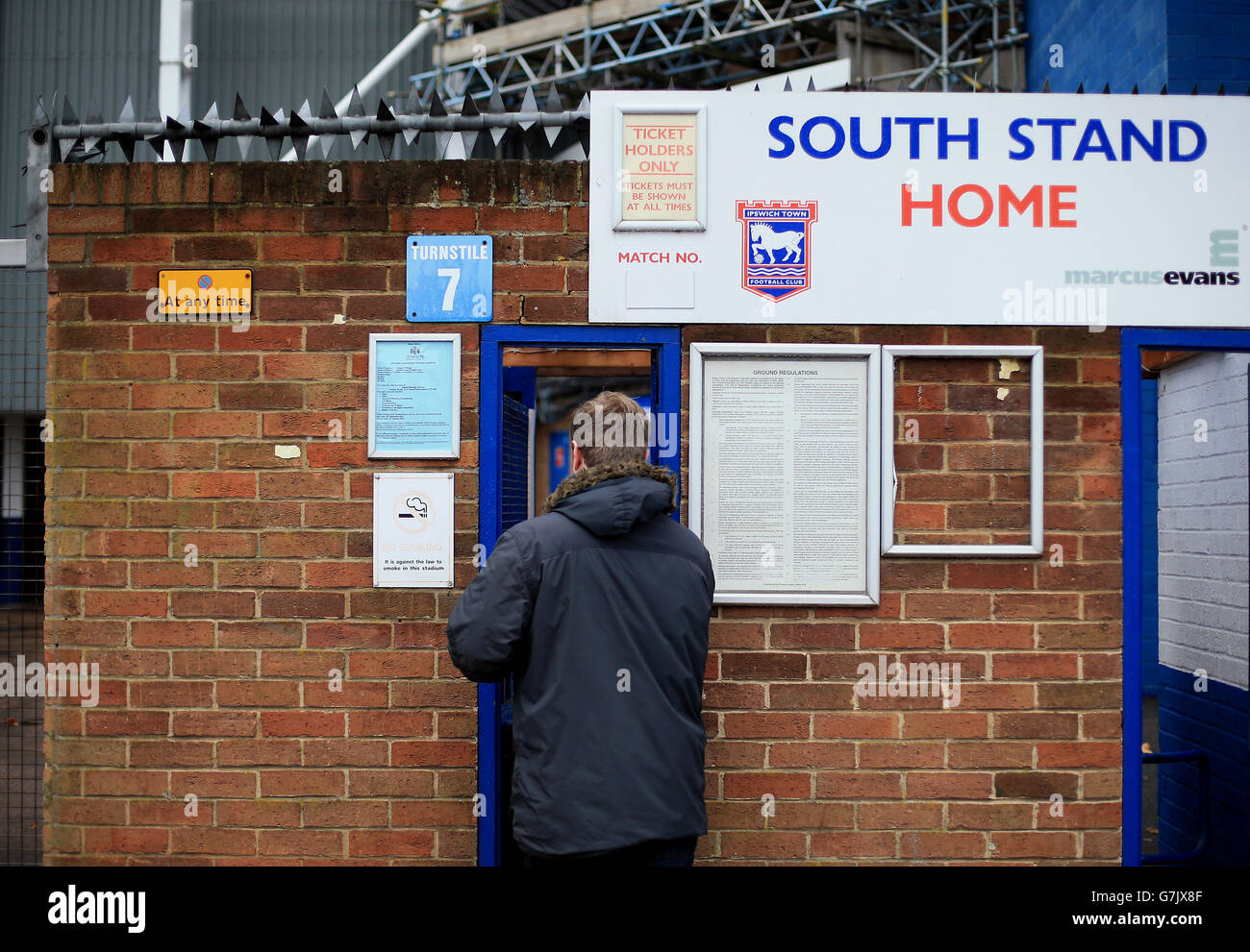 Fans make their way through the turnstiles into the ground before the ...