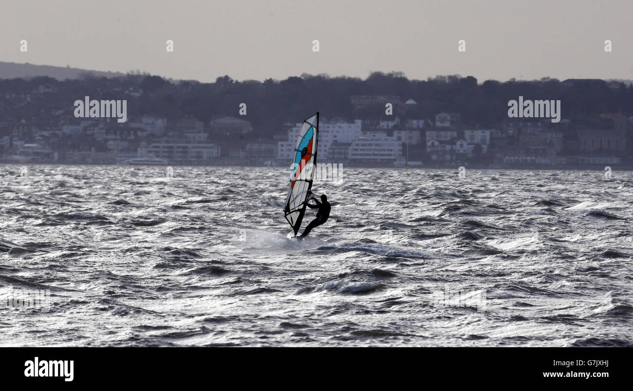 A wind surfer in the Solent as high winds have brought another day of ...