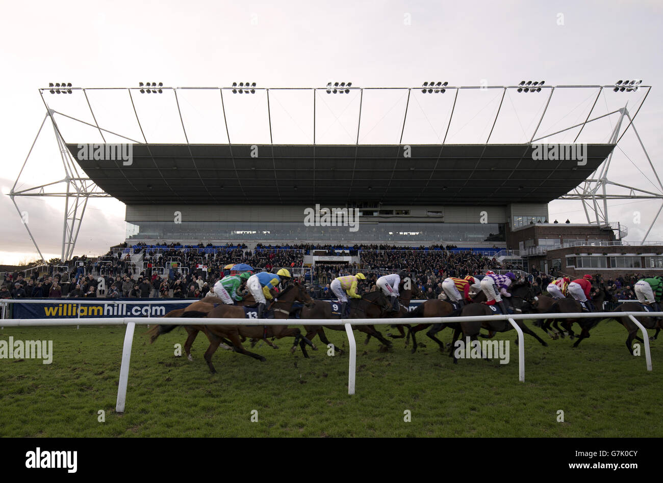 William Hill branding and racegoers in the grandstand at Kempton Park ...