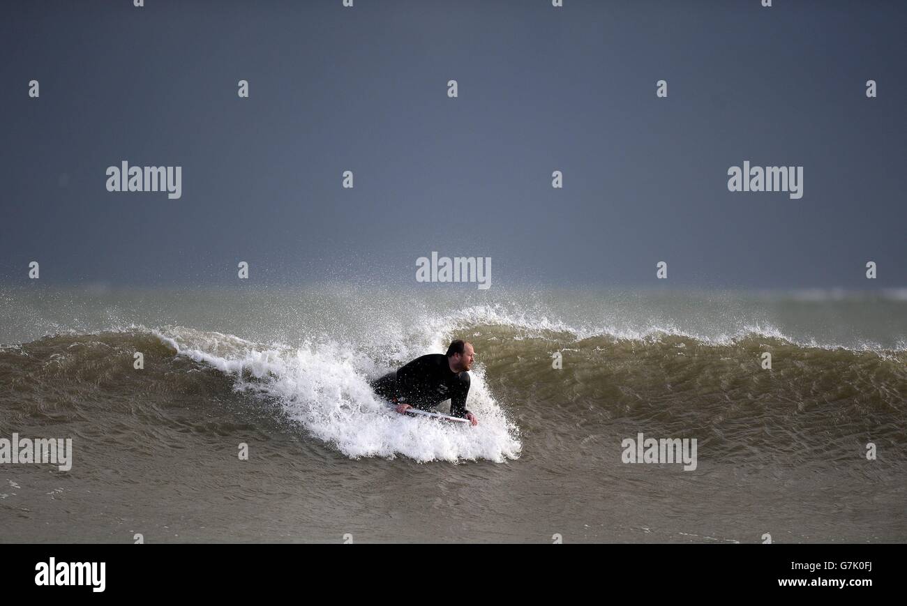 A body border enjoys surf on north beach in swanage hi-res stock ...