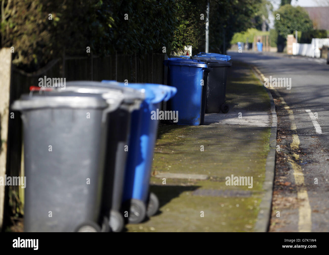 Rubbish stock. Rubbish (black) and recycling bins line a street in ...
