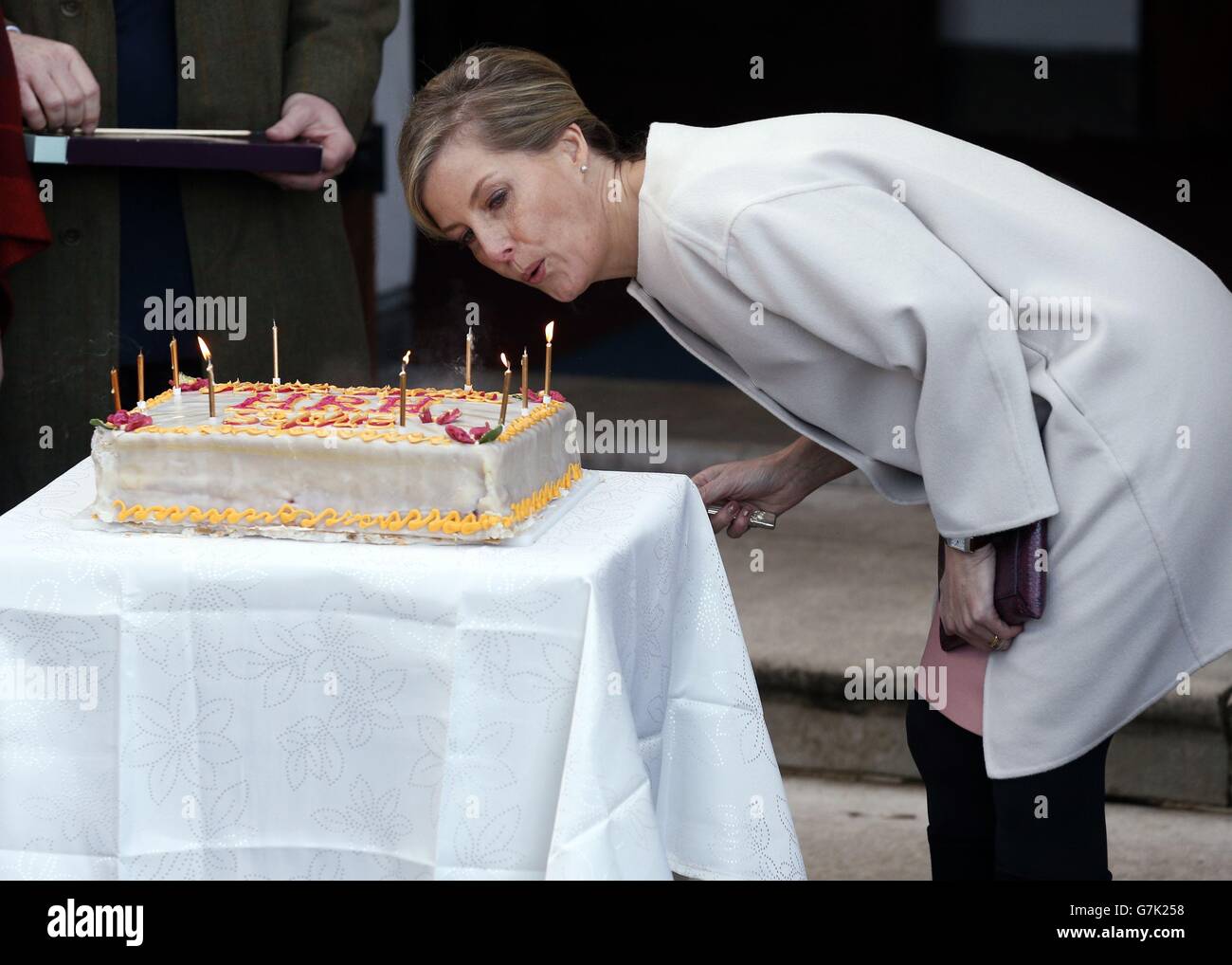 The Countess of Wessex blows out candles on a birthday cake as she ...