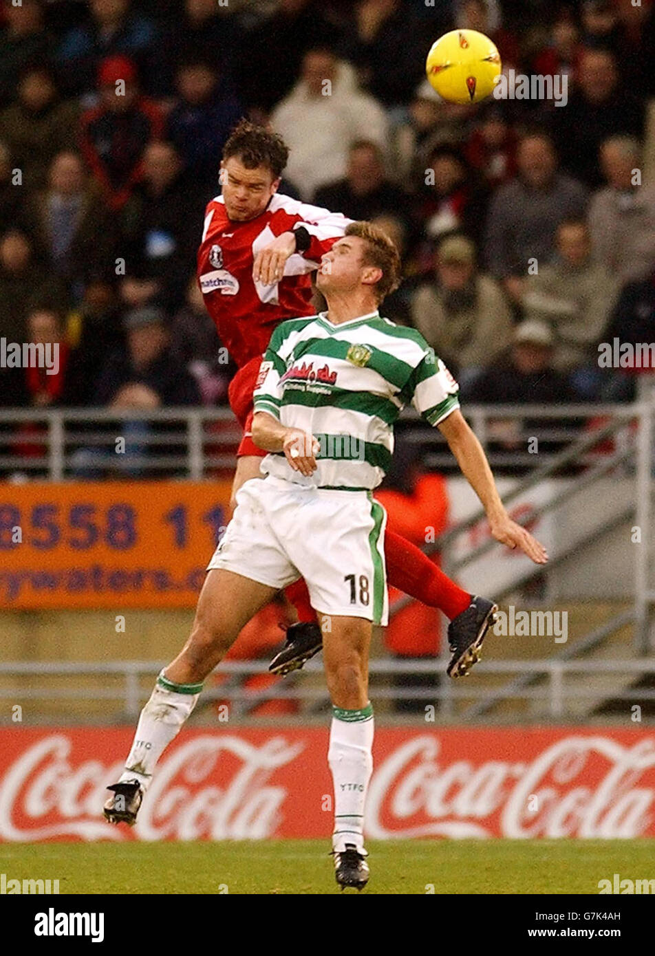 Yeovil's Bartos Tarachulski (right) is beaten in the air by Leyton ...