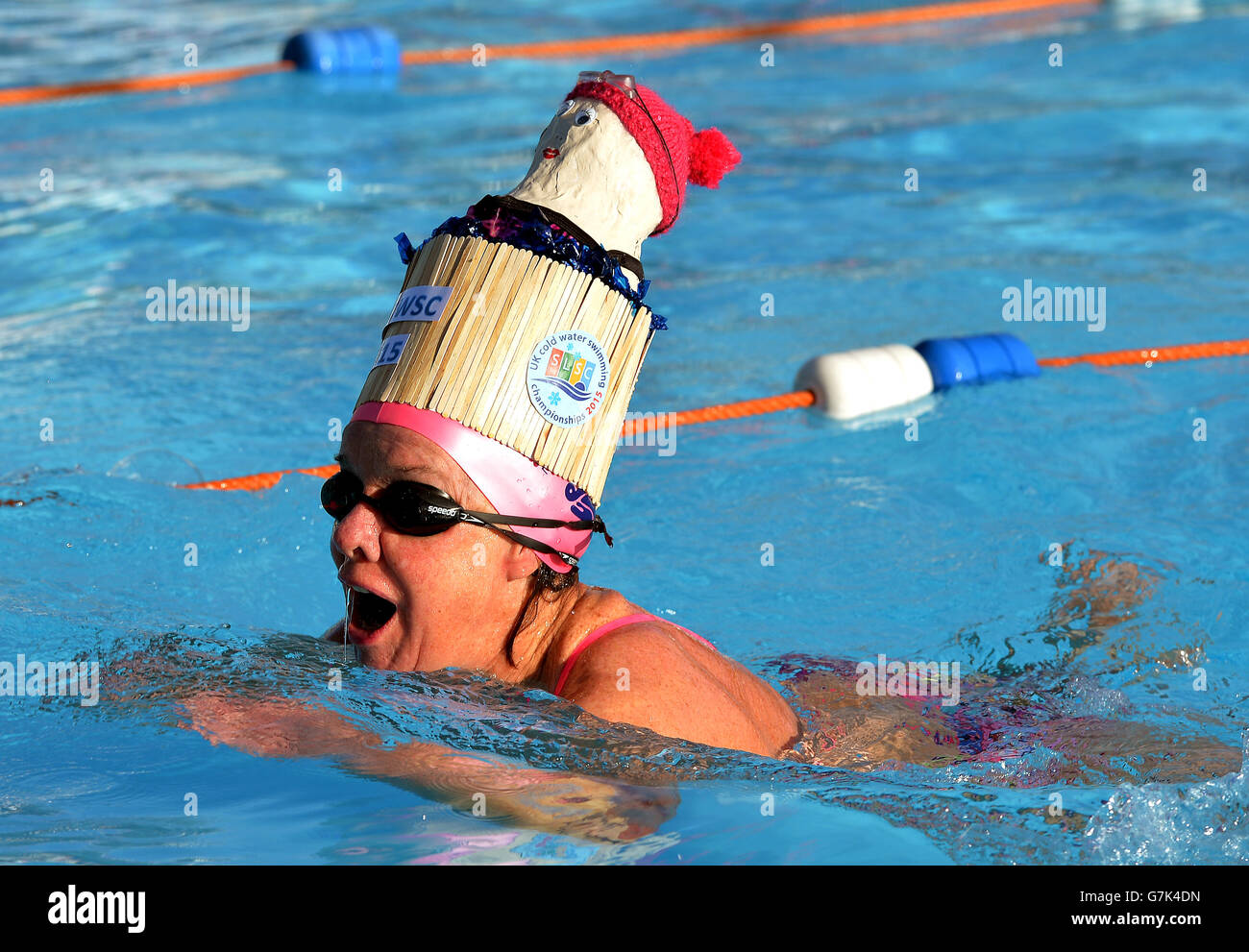 A competitor takes part in the fancy Hat swimming race during the 6th ...