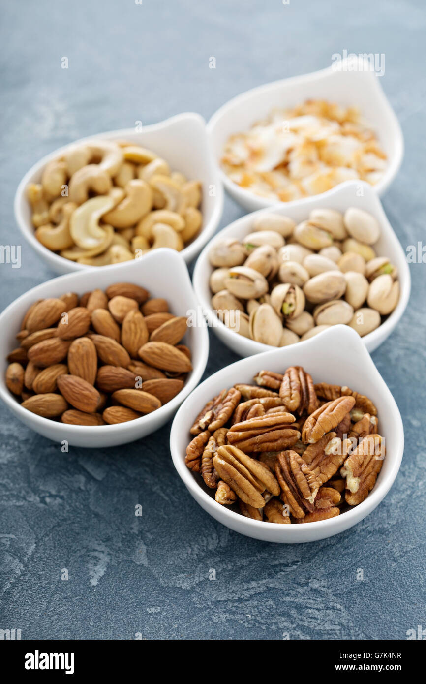 Variety of nuts in small white bowls healthy snacks Stock Photo - Alamy
