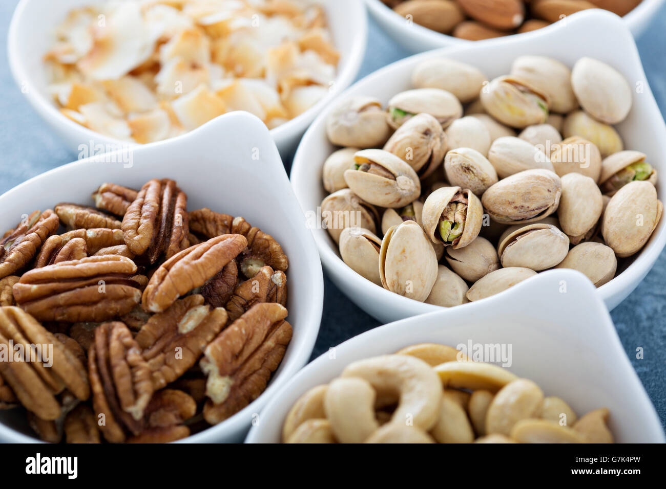Variety of nuts in small white bowls healthy snacks Stock Photo - Alamy