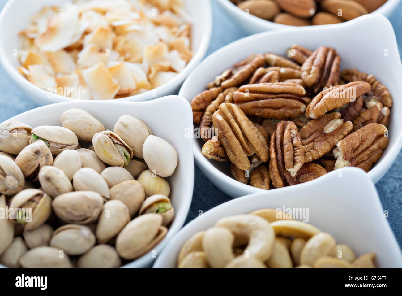 Variety of nuts in small white bowls healthy snacks Stock Photo - Alamy