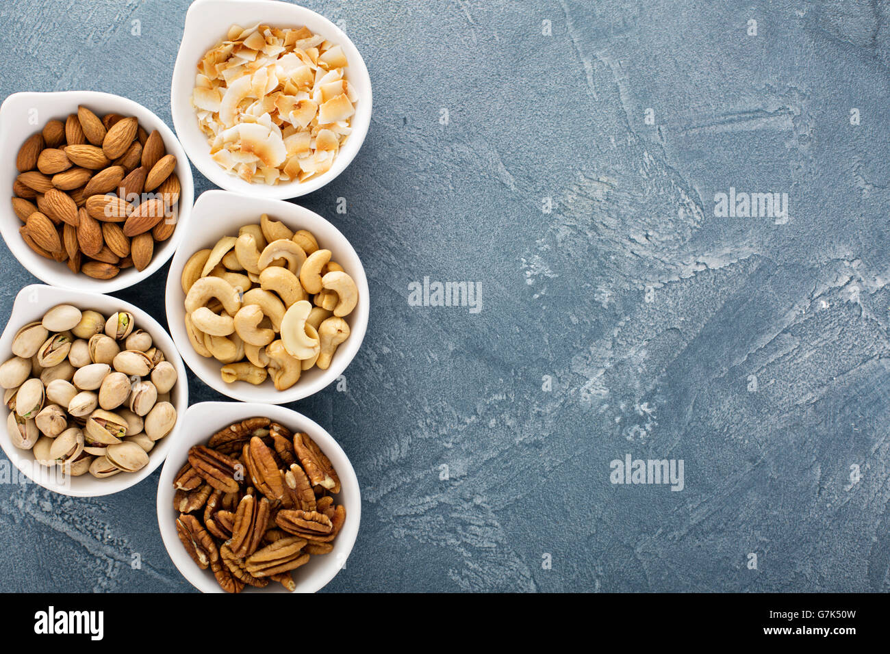 Variety of nuts in small white bowls healthy snacks Stock Photo - Alamy