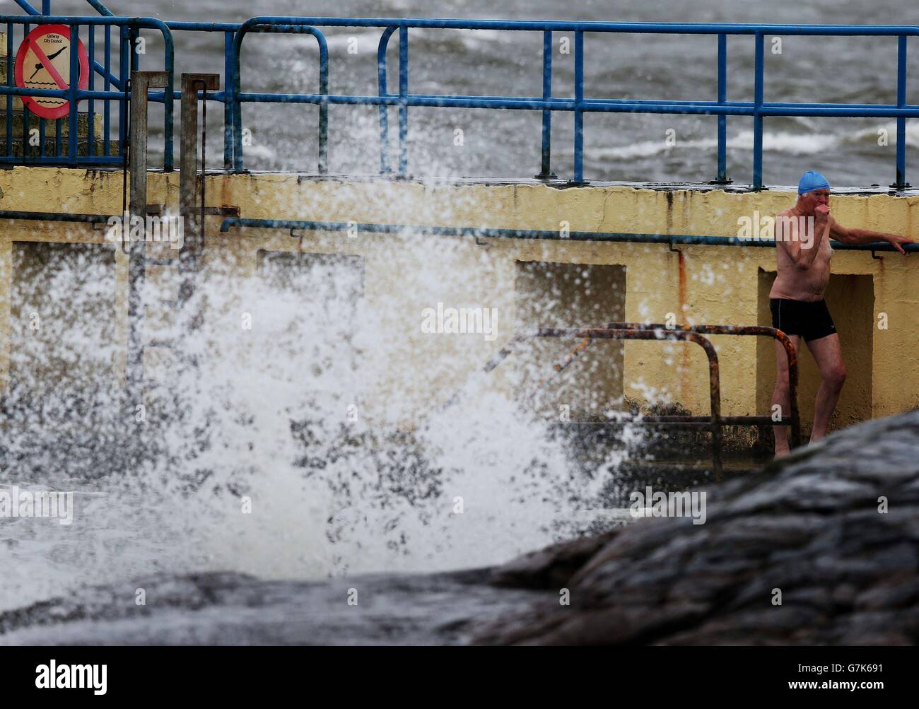 Local priest Fr. Oliver Powell leaves the sea at Salthill, Galway, as ...