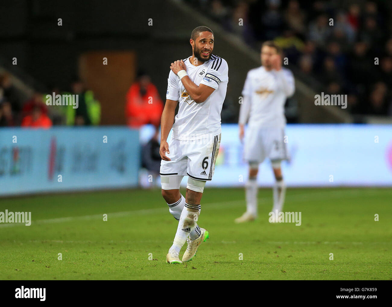 Swansea City's Ashley Williams pulls up with an injury during the ...