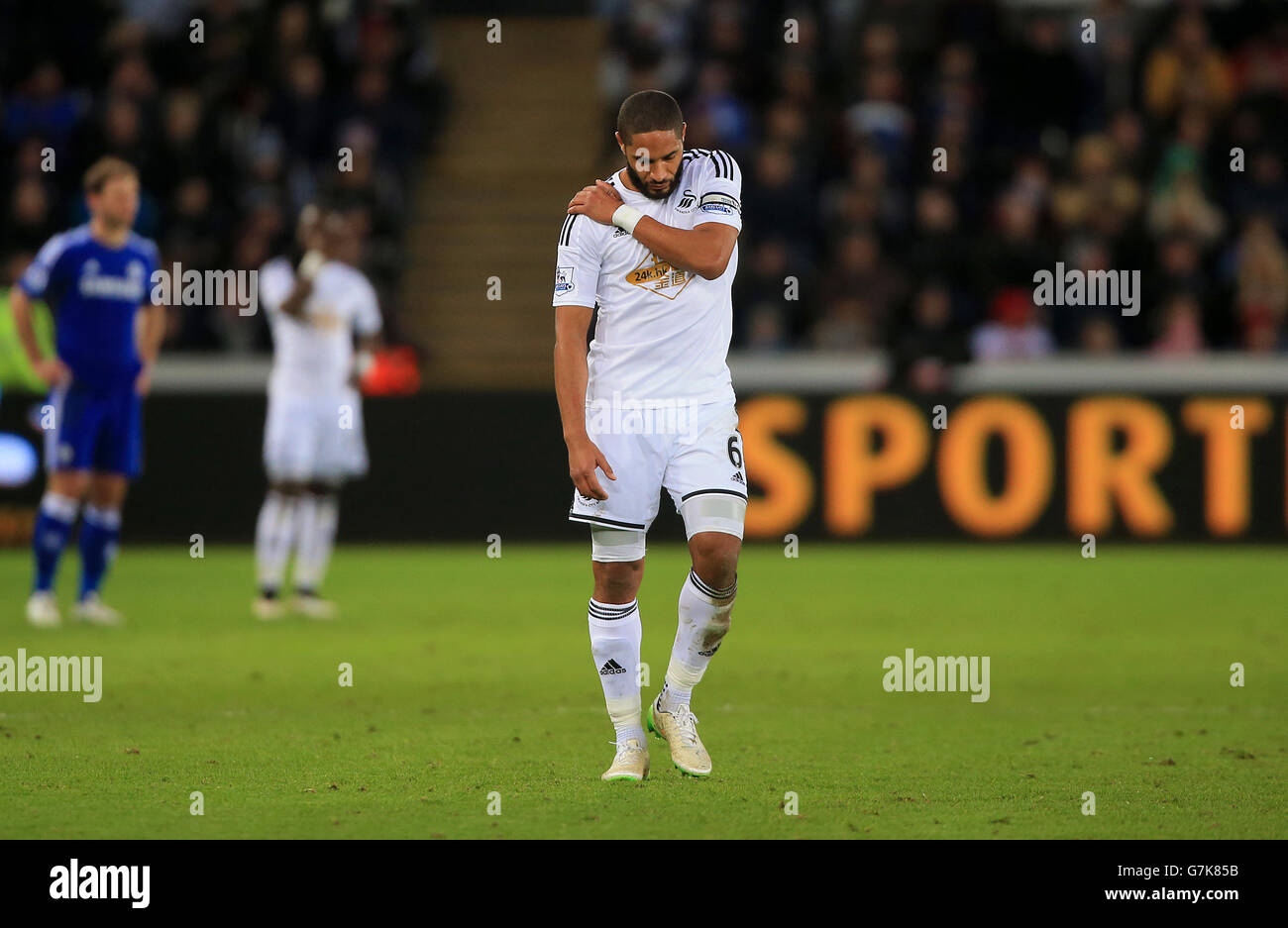 Swansea City's Ashley Williams pulls up with an injury during the ...