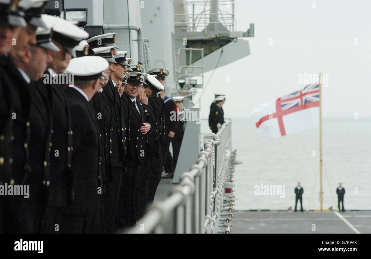 HMS Illustrious and her crew sail into Portsmouth Harbour in Hampshire ...