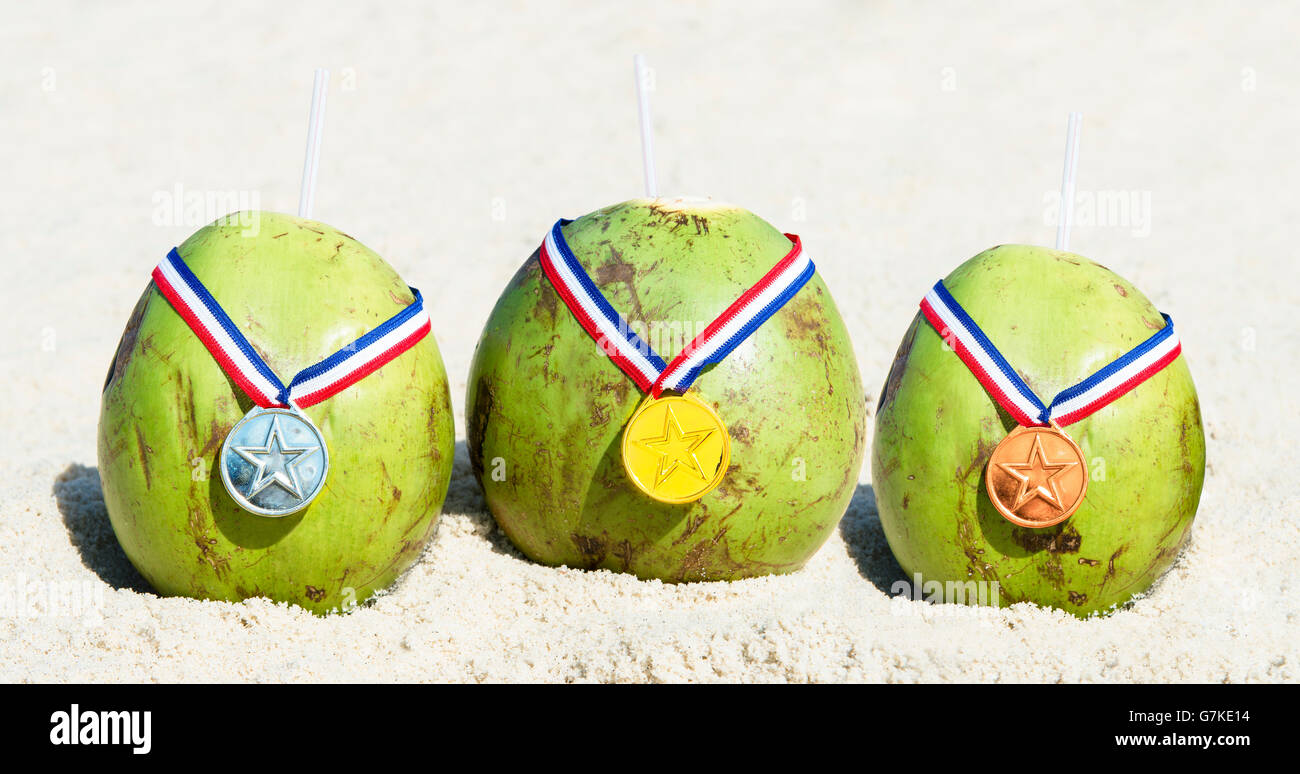 Three green Brazilian coco gelado drinking coconuts wear gold, silver ...