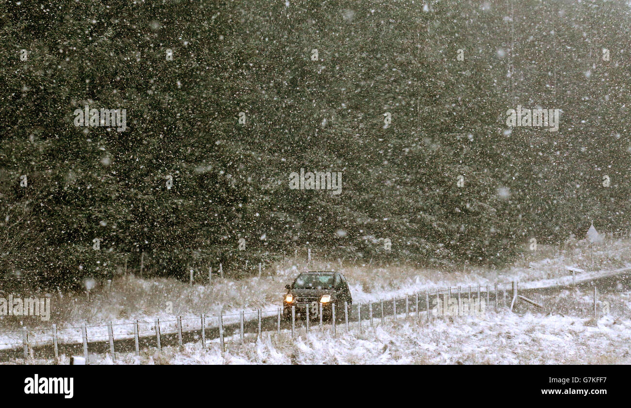 Car travels along road in snow blizzard conditons near dunblane hi-res ...