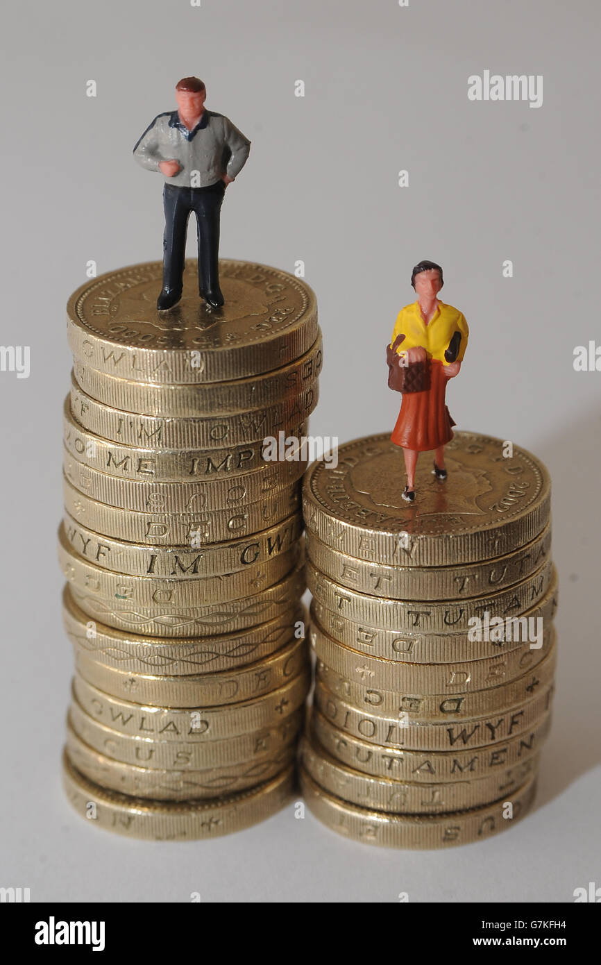 Plastic models of man woman stand on pile of coins hi-res stock ...